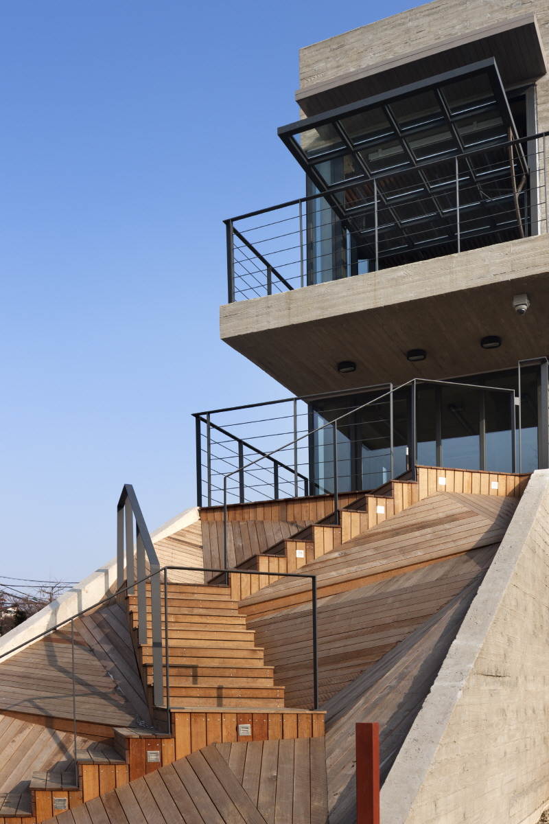 Zig-Zagging Wooden Stairway Leads to Book-Shaped Building - WebUrbanist