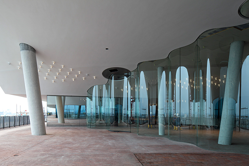 Glittering Wave-Shaped Concert Hall Placed Atop Old Warehouse Building ...