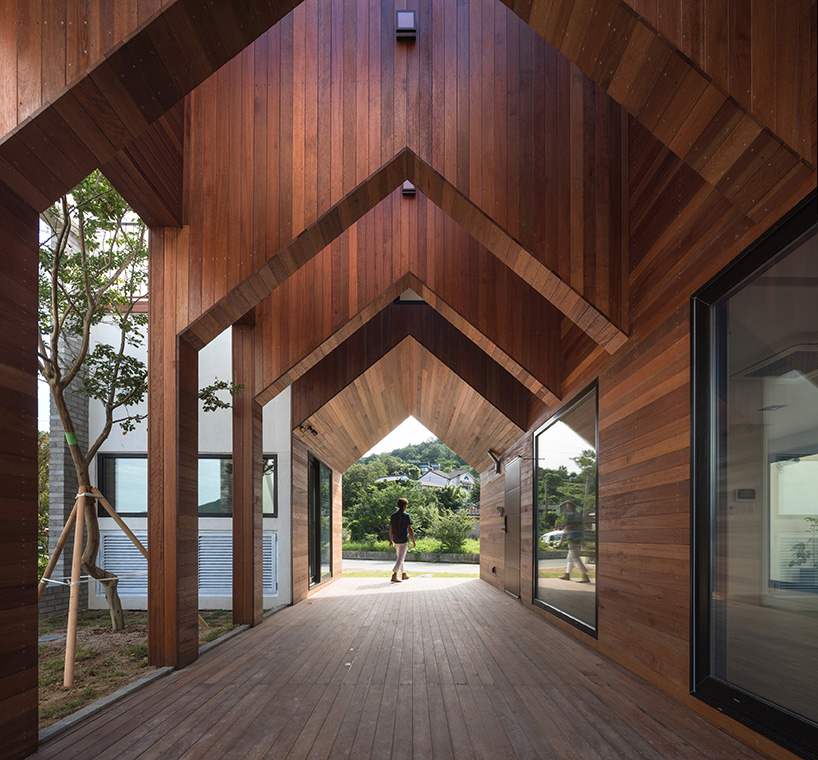 Vernacular Void: Wood Walls Warm Negative Space in Gray Brick Home ...
