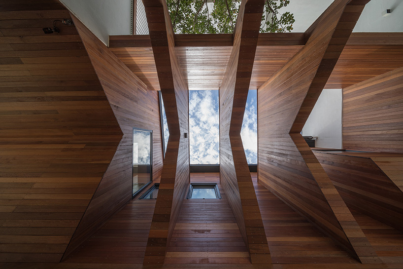 Vernacular Void: Wood Walls Warm Negative Space in Gray Brick Home ...