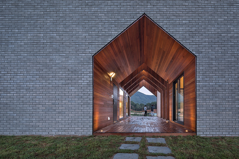 Vernacular Void: Wood Walls Warm Negative Space in Gray Brick Home ...
